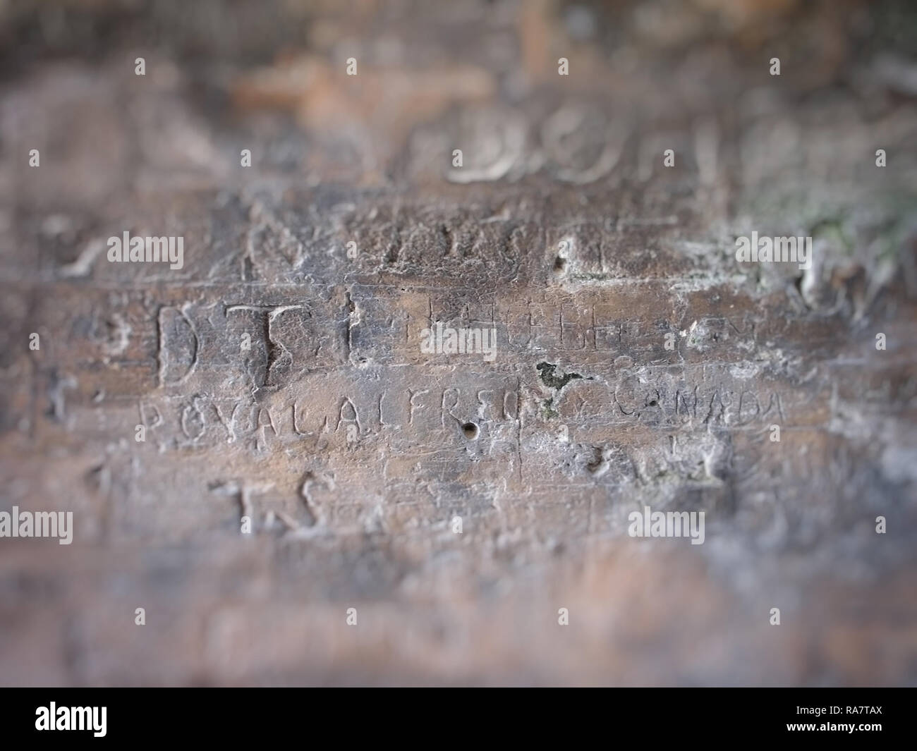 Engraved writings on stone wall Stock Photo - Alamy