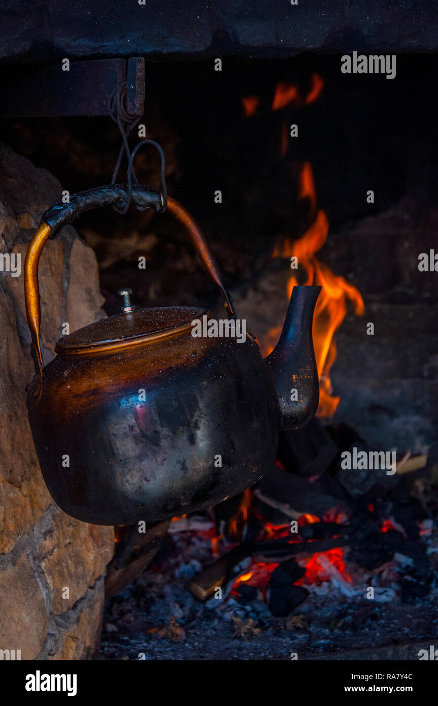 Old teapot full of the water put on the fire to make tea outdoor Stock ...