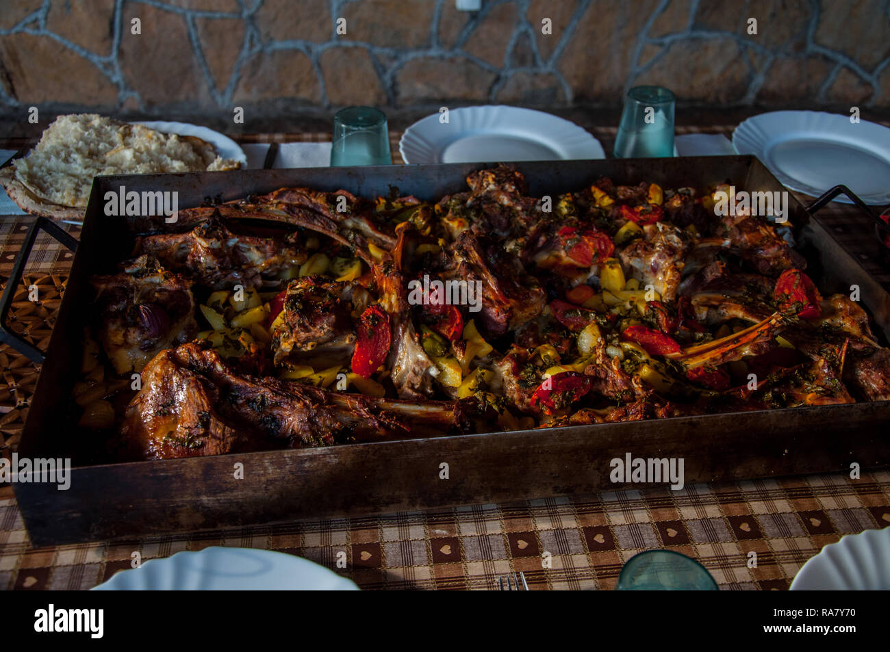 Traditional Bosnian meal served on the table, meat with vegetables in ...