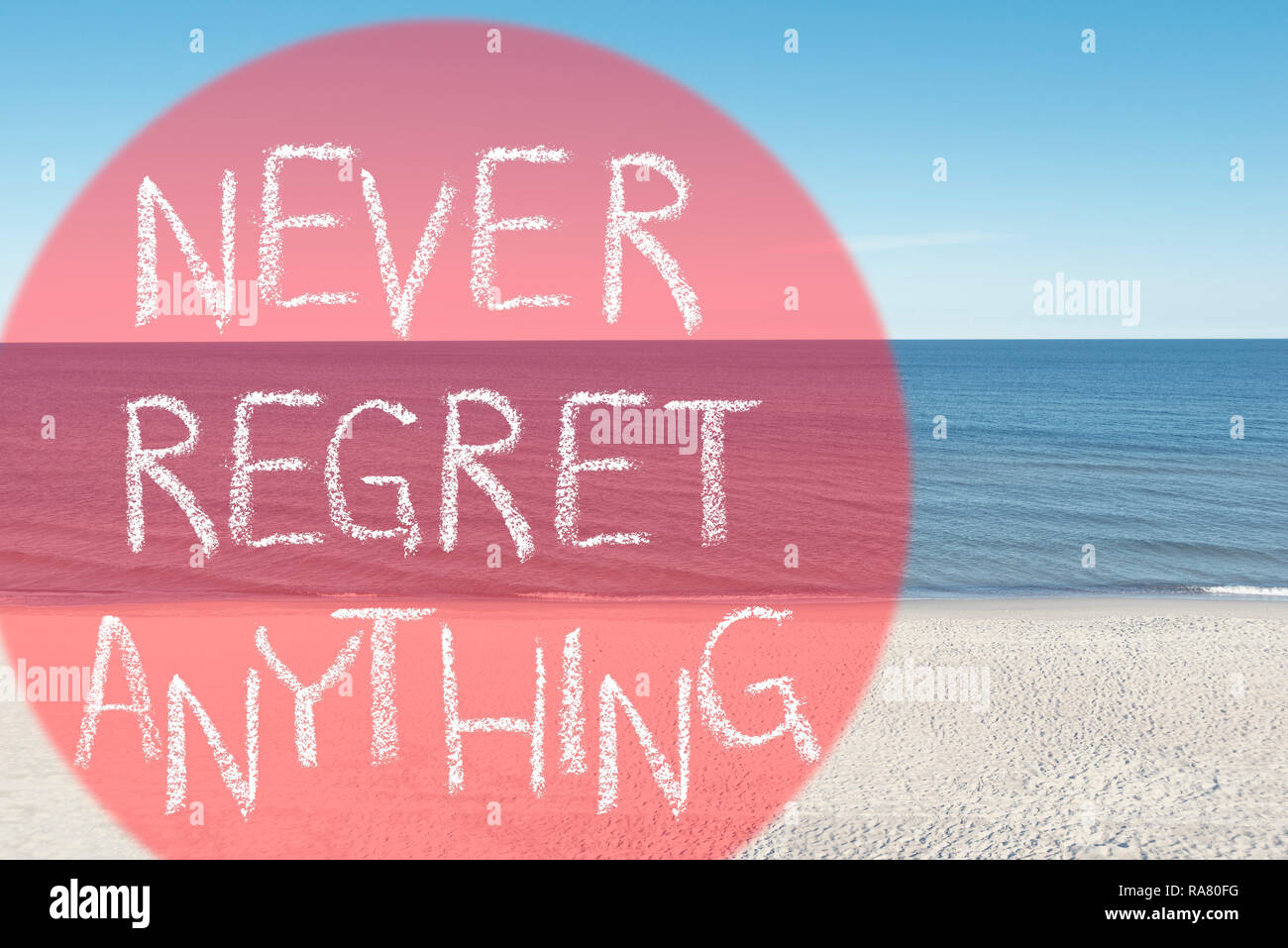never regret anything slogan handwritten on empty beach background ...