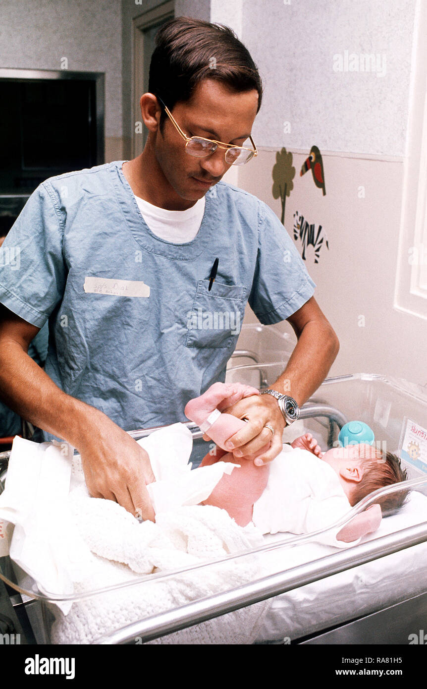 Worker changing diaper 1970s hi-res stock photography and images - Alamy