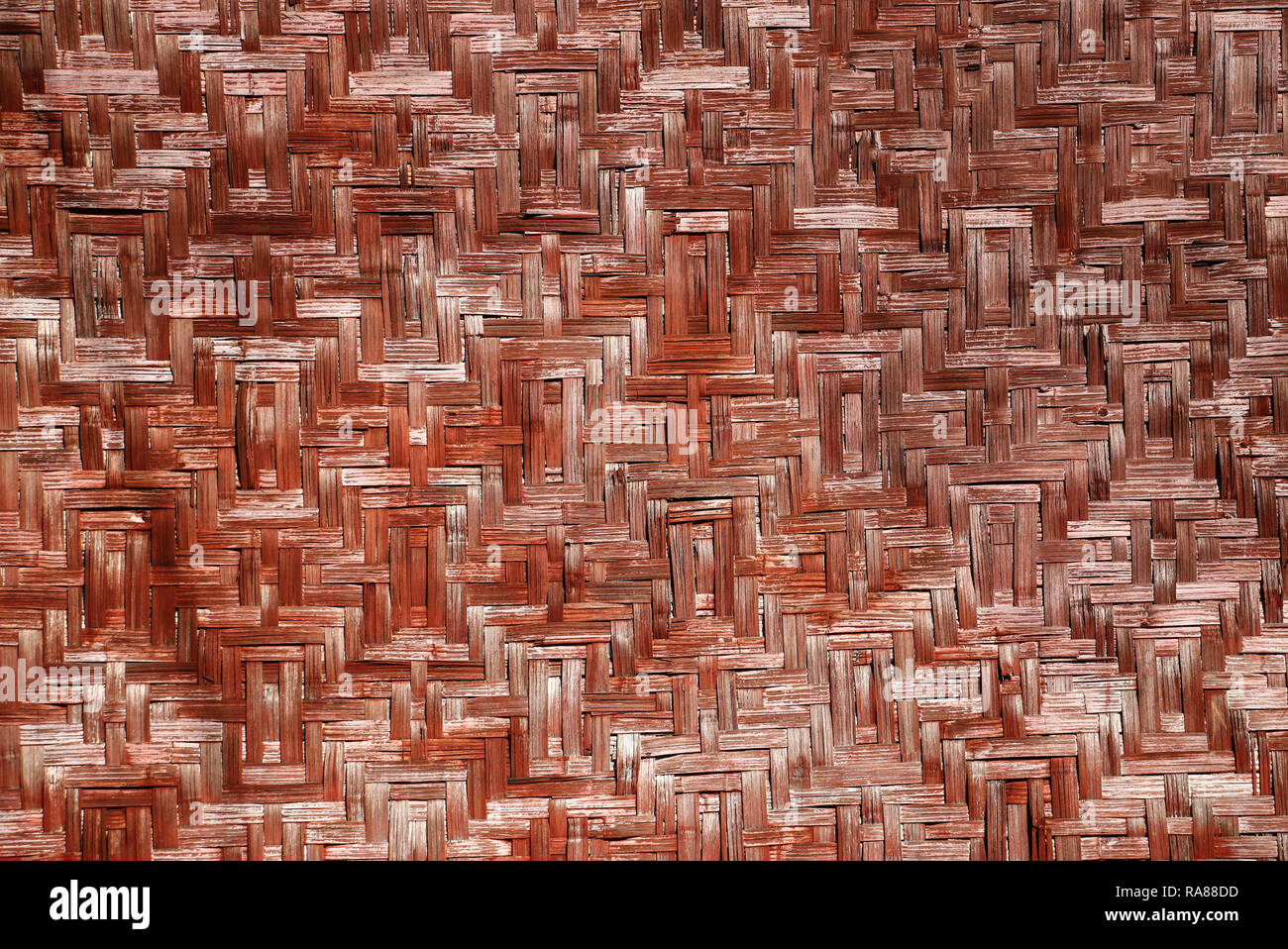 Texture of the old wicker mat of bamboo red color Stock Photo - Alamy