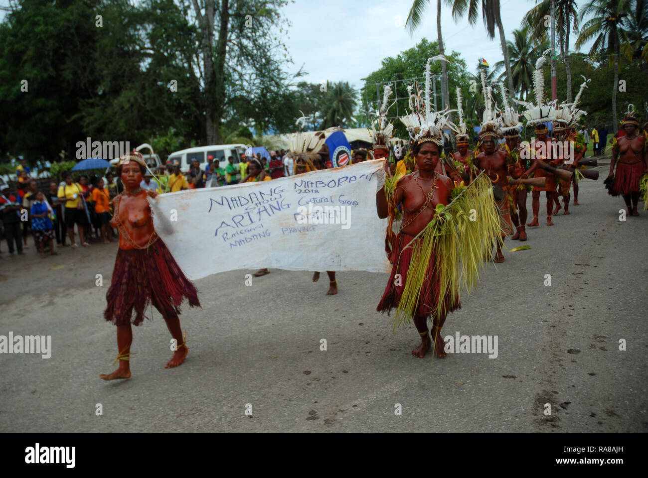 Colourfully dressed and face painted women singing and dancing at the ...