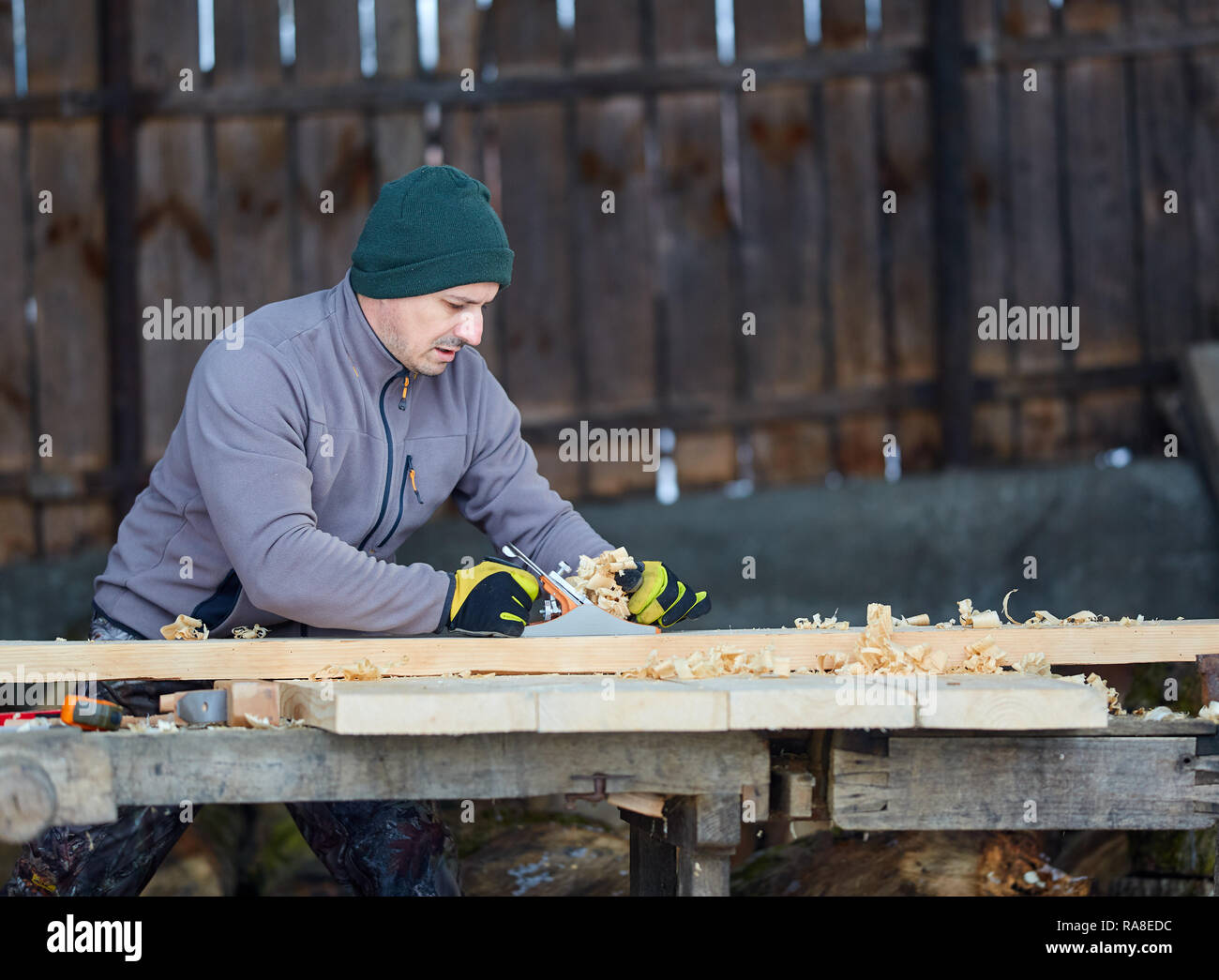 Woodworking - man using hand planer on a pine wood Stock Photo - Alamy