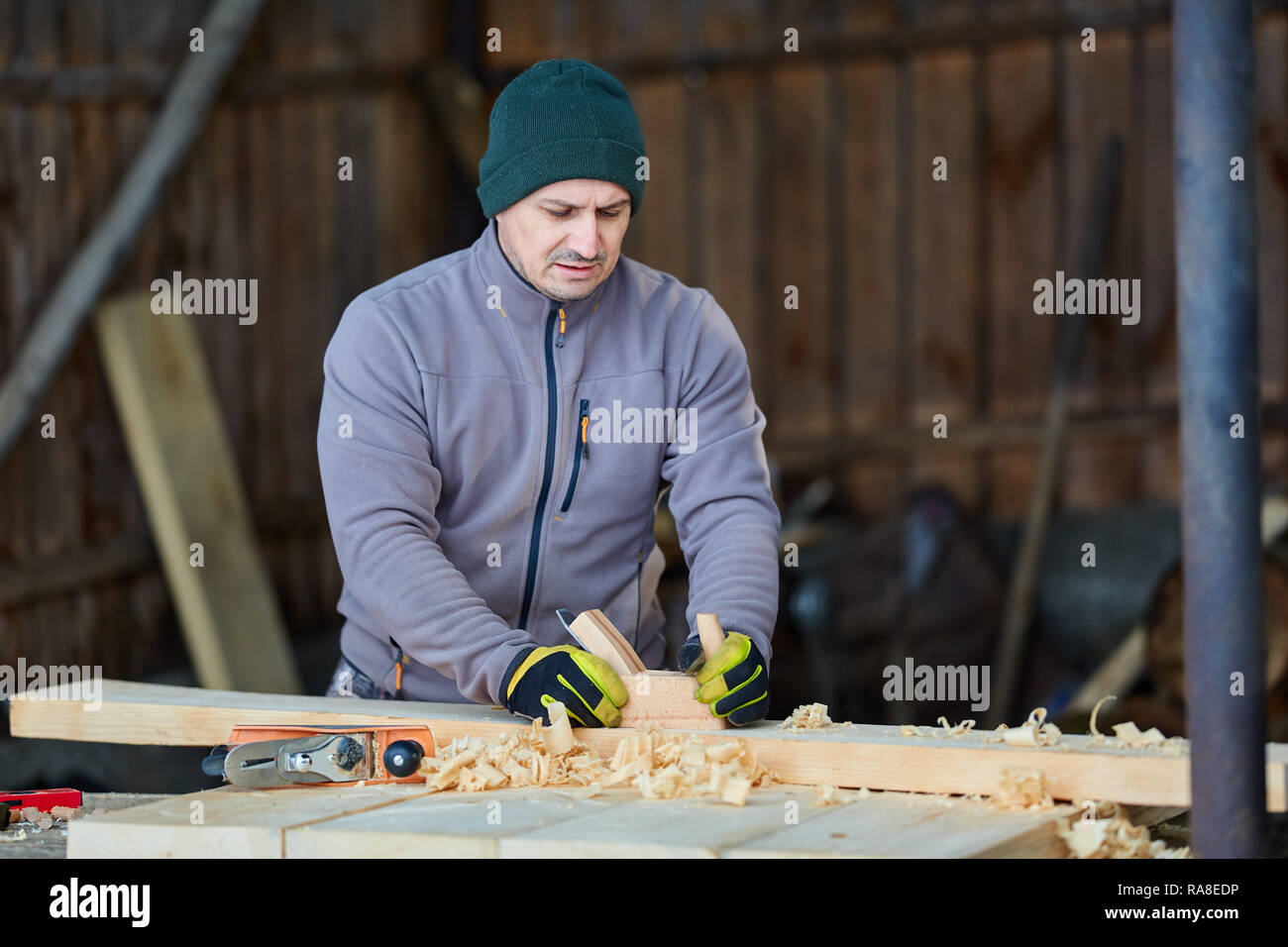 Woodworking - man using hand planer on a pine wood Stock Photo - Alamy