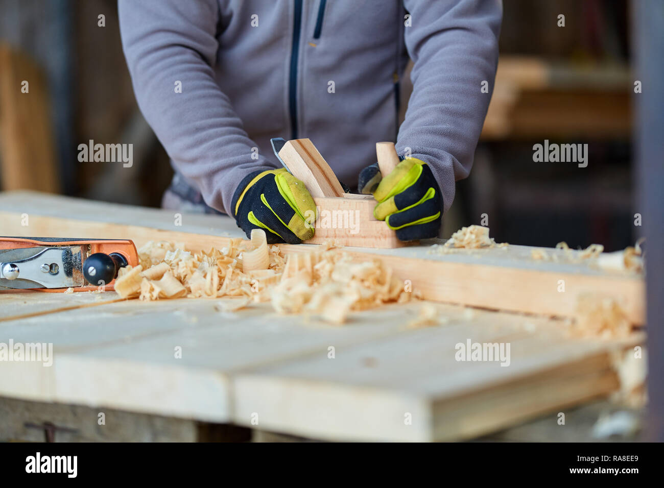 Woodworking - man using hand planer on a pine wood Stock Photo - Alamy