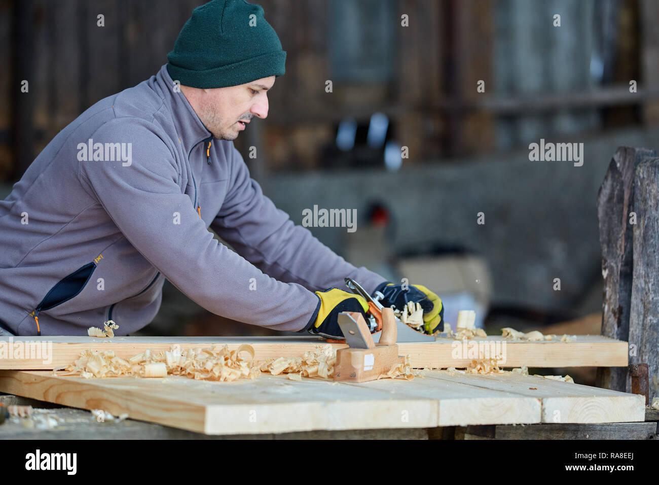 Woodworking - man using hand planer on a pine wood Stock Photo - Alamy