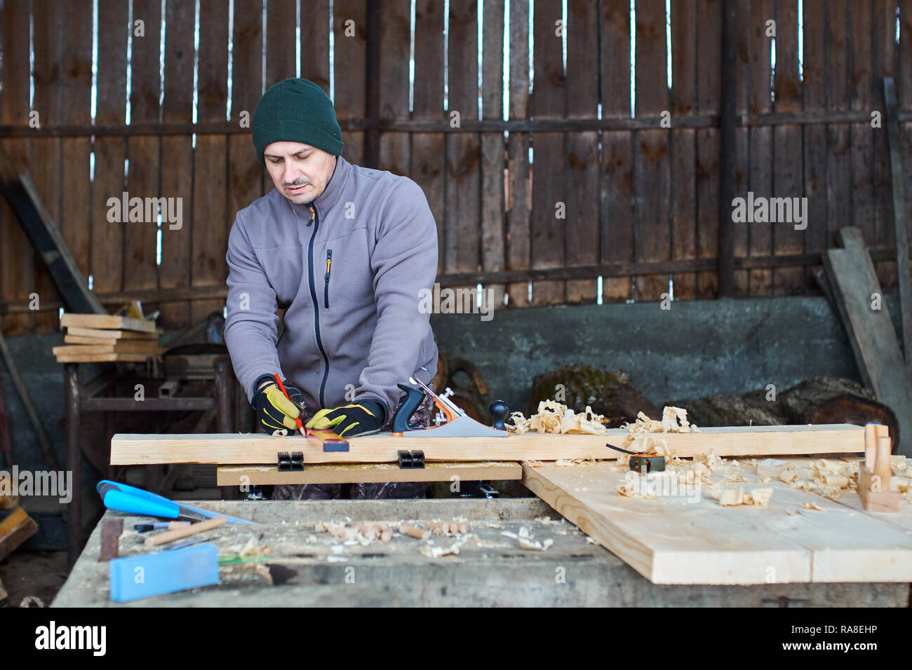Woodworker measuring and drawing lines on his cabinet project Stock ...