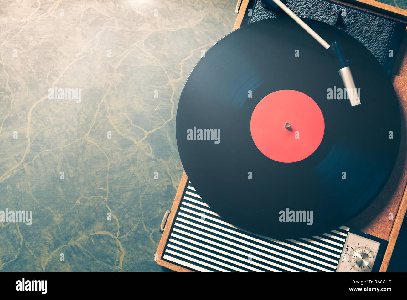 Older Gramophone with a vinyl record on wooden table, top view and copy ...