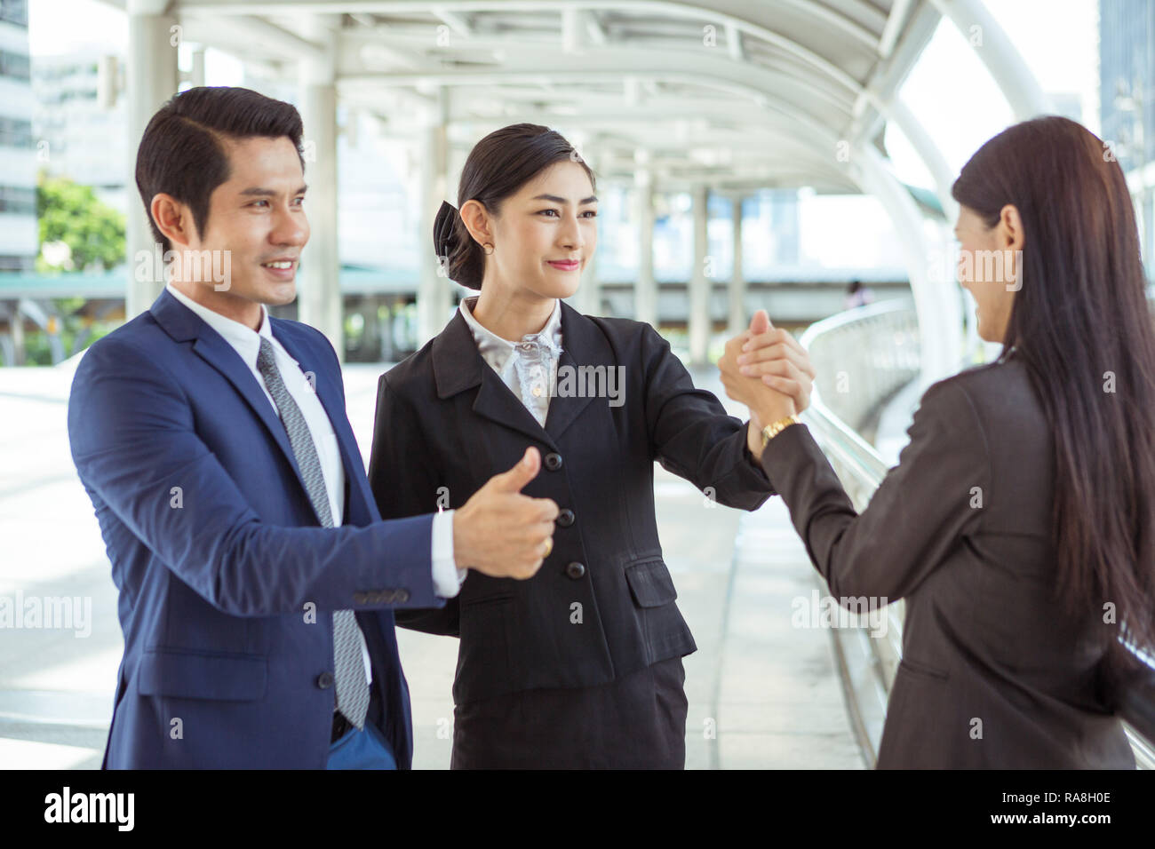 Teamwork of Asian business peoples Stock Photo - Alamy