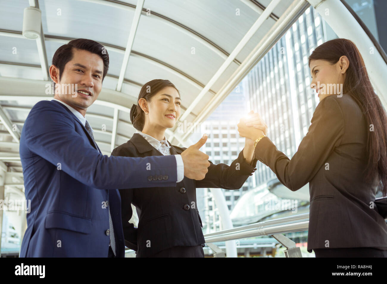 Teamwork of Asian business peoples Stock Photo - Alamy