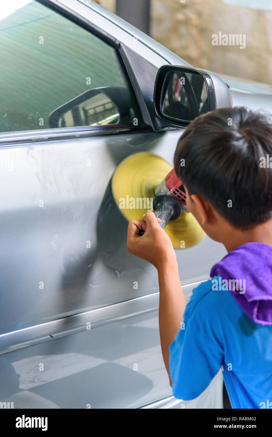 Worker polish the car by Car polishing machine Stock Photo - Alamy