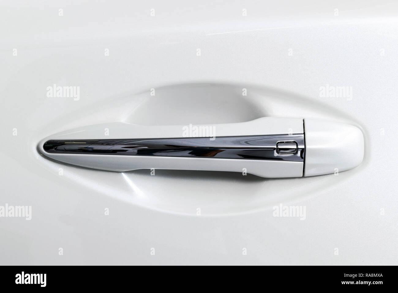 The modern door handle of a white car. Car detailing. Car exterior ...
