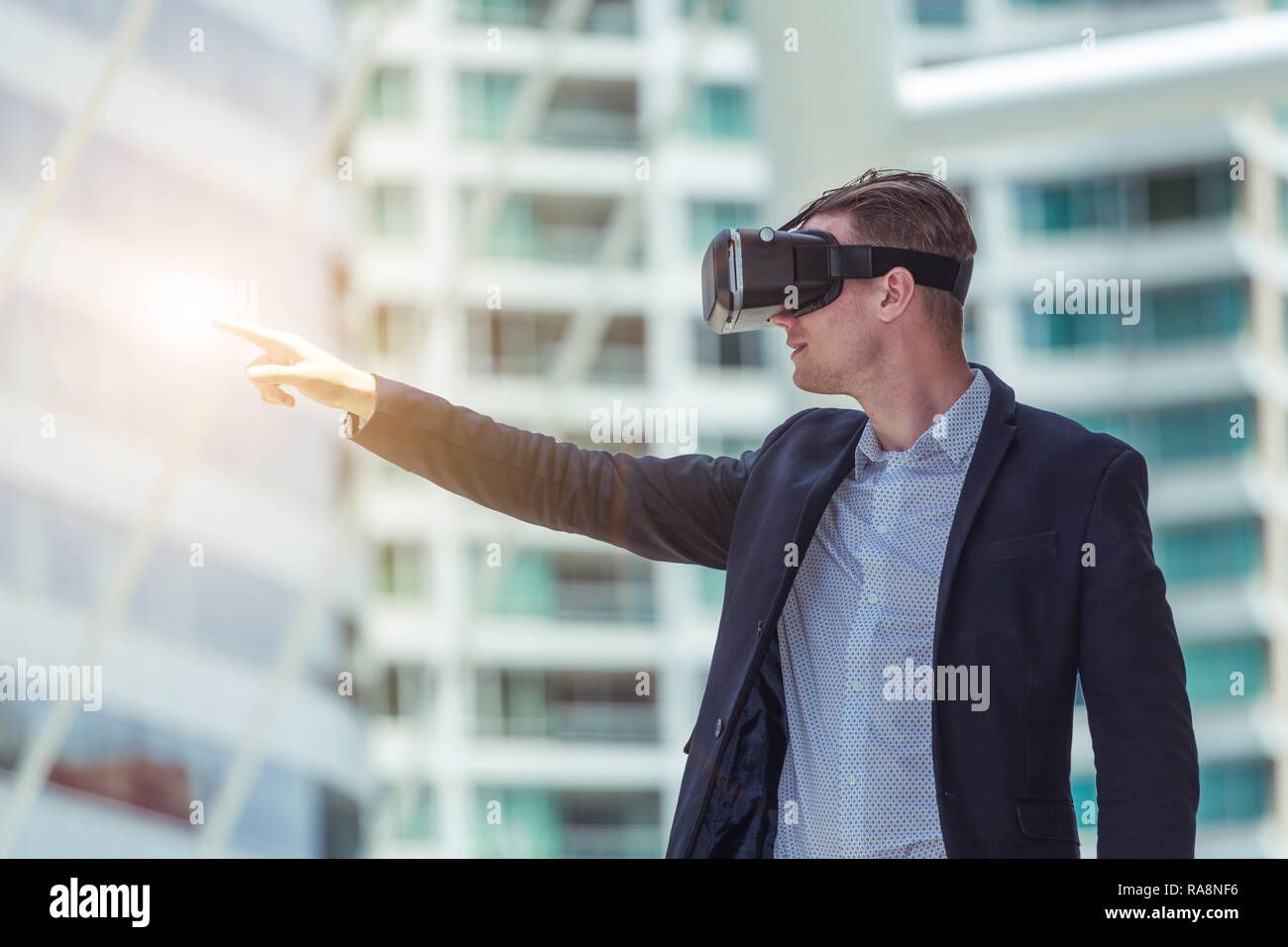 Caucasian play a VR simulation outdoor background Stock Photo - Alamy