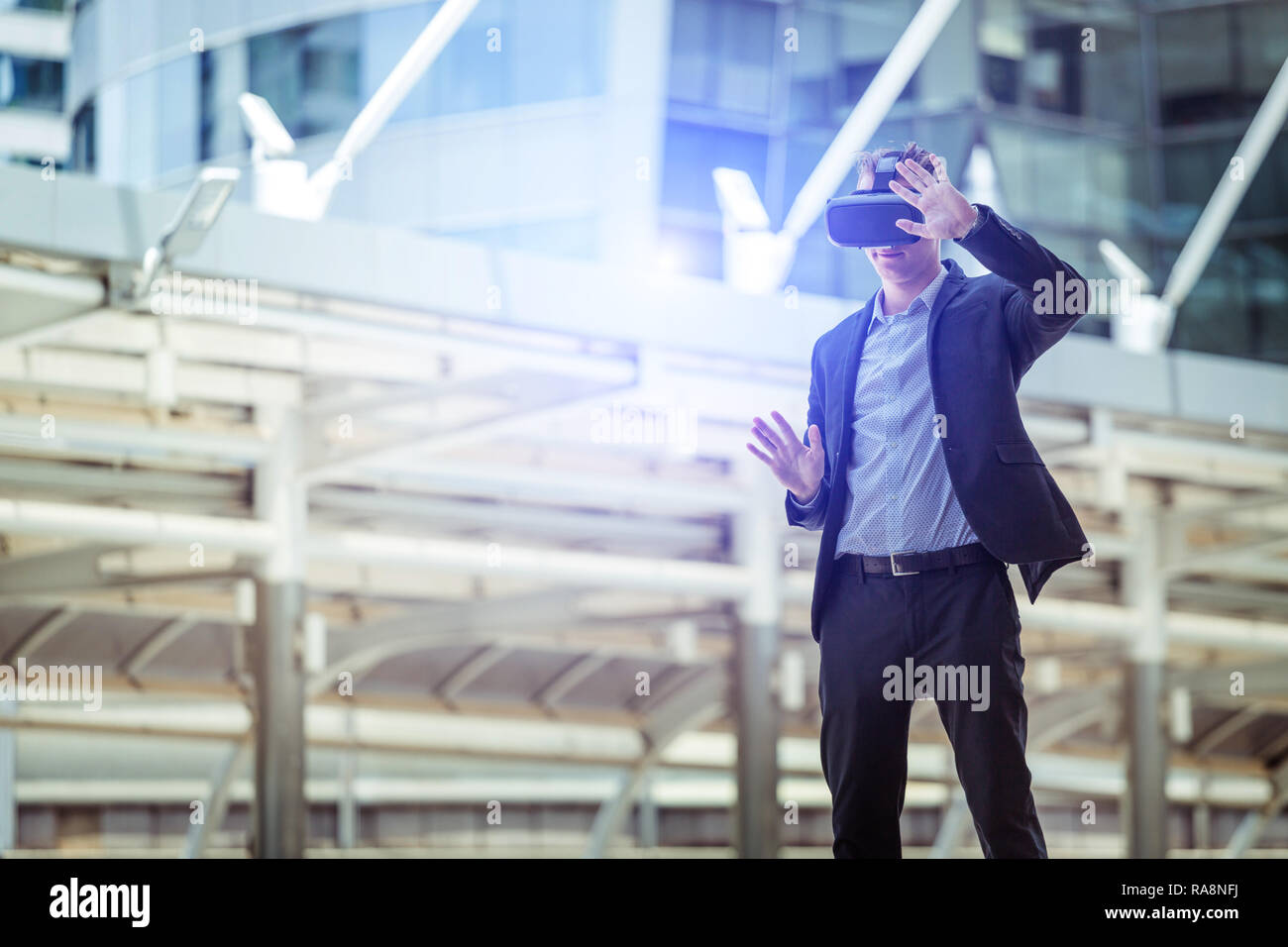 Caucasian play a VR simulation outdoor background Stock Photo - Alamy