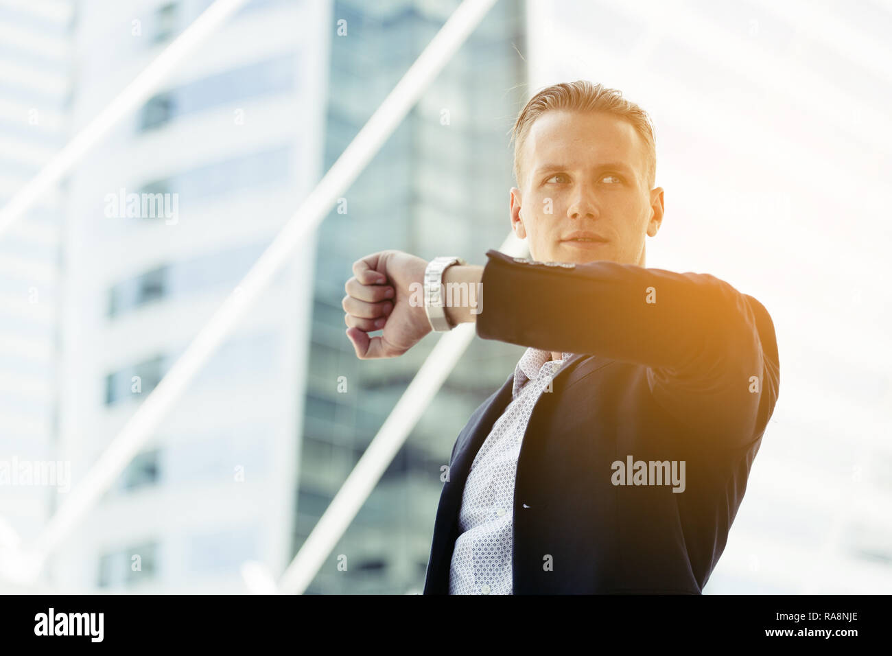 Smart businessguy looking watch in rush hour time Stock Photo - Alamy
