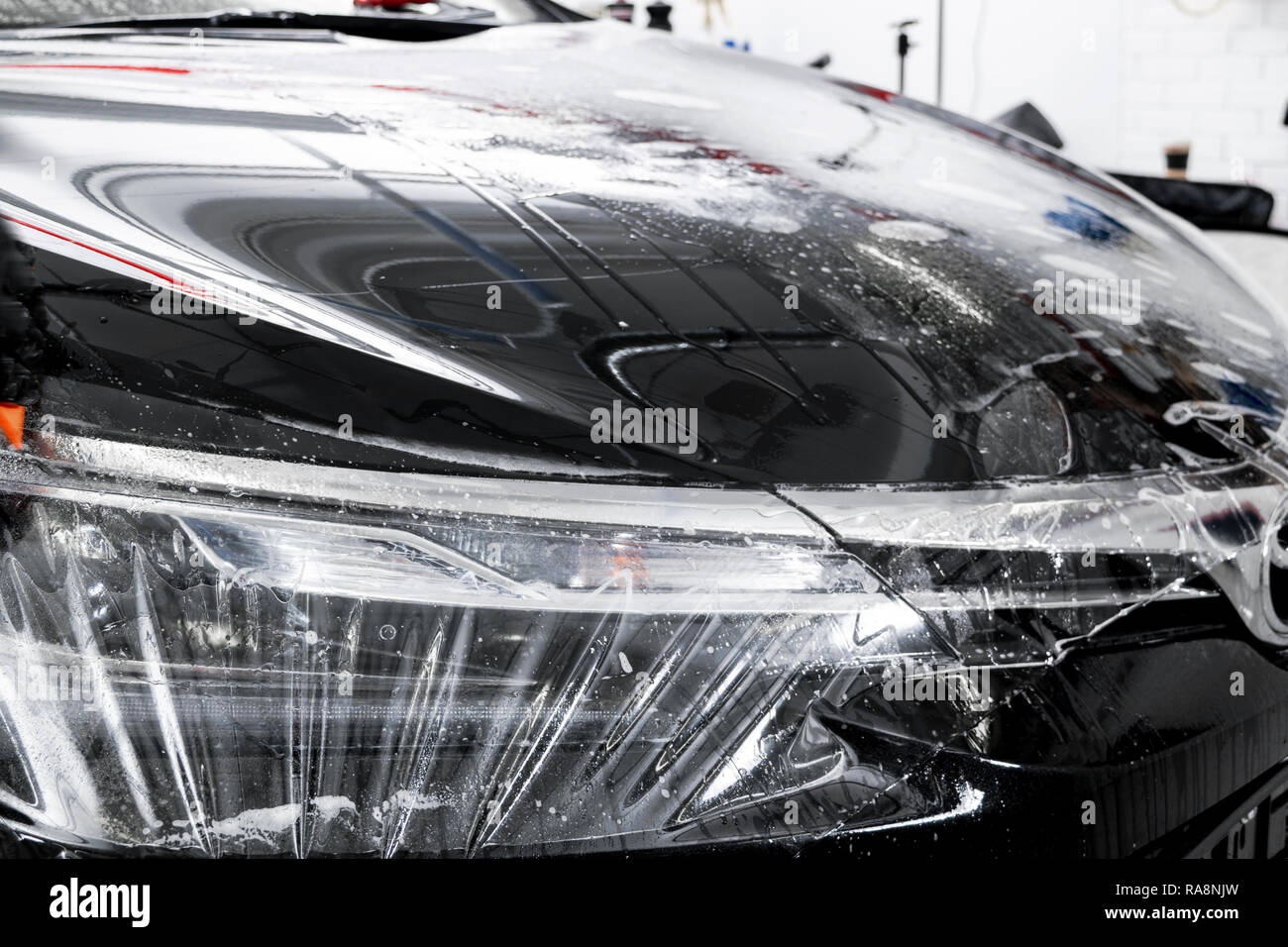 Car wrapping specialist putting vinyl foil or film on car. Protective ...