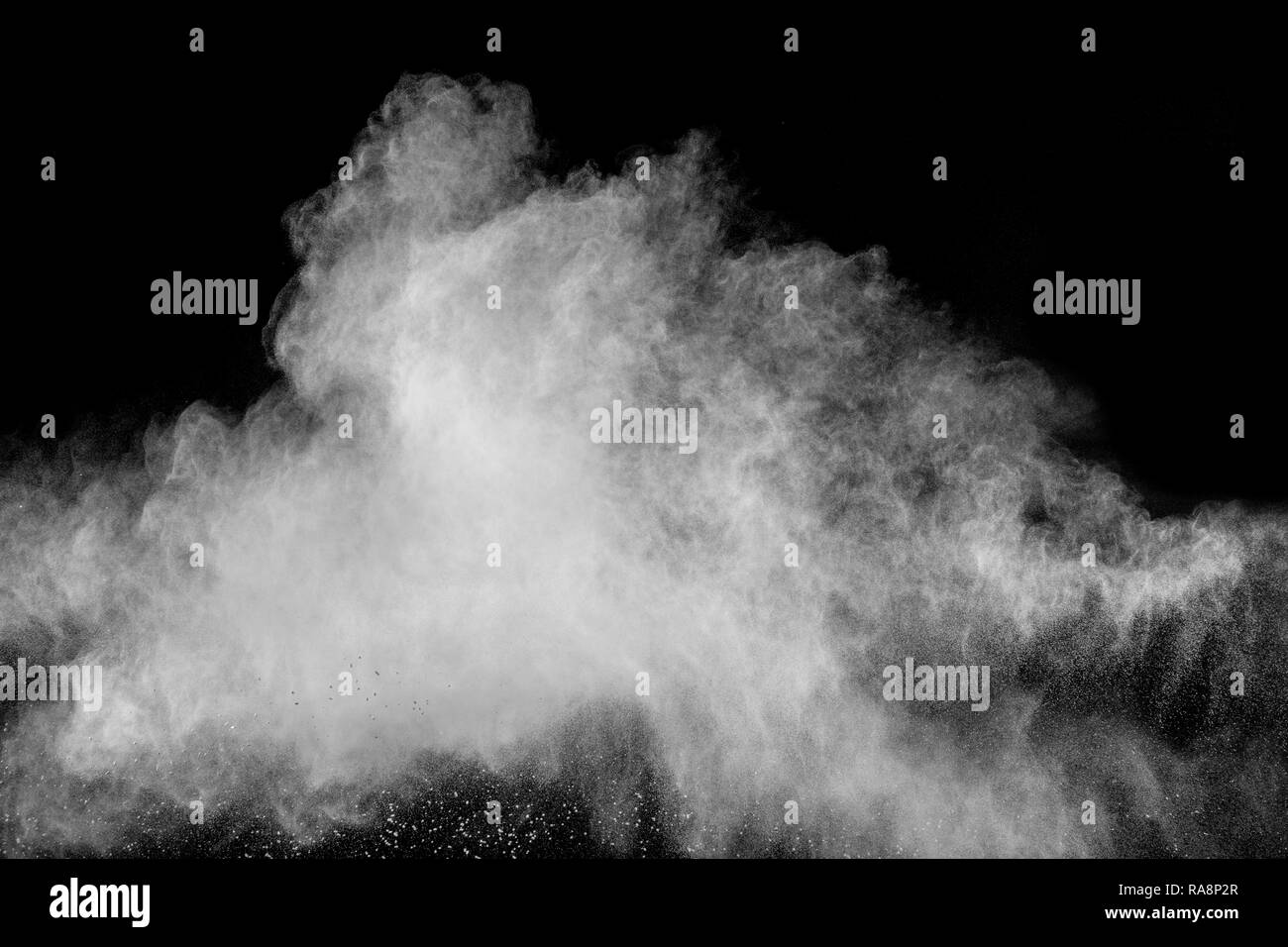 Freeze motion of white dust particles on black background. White powder ...