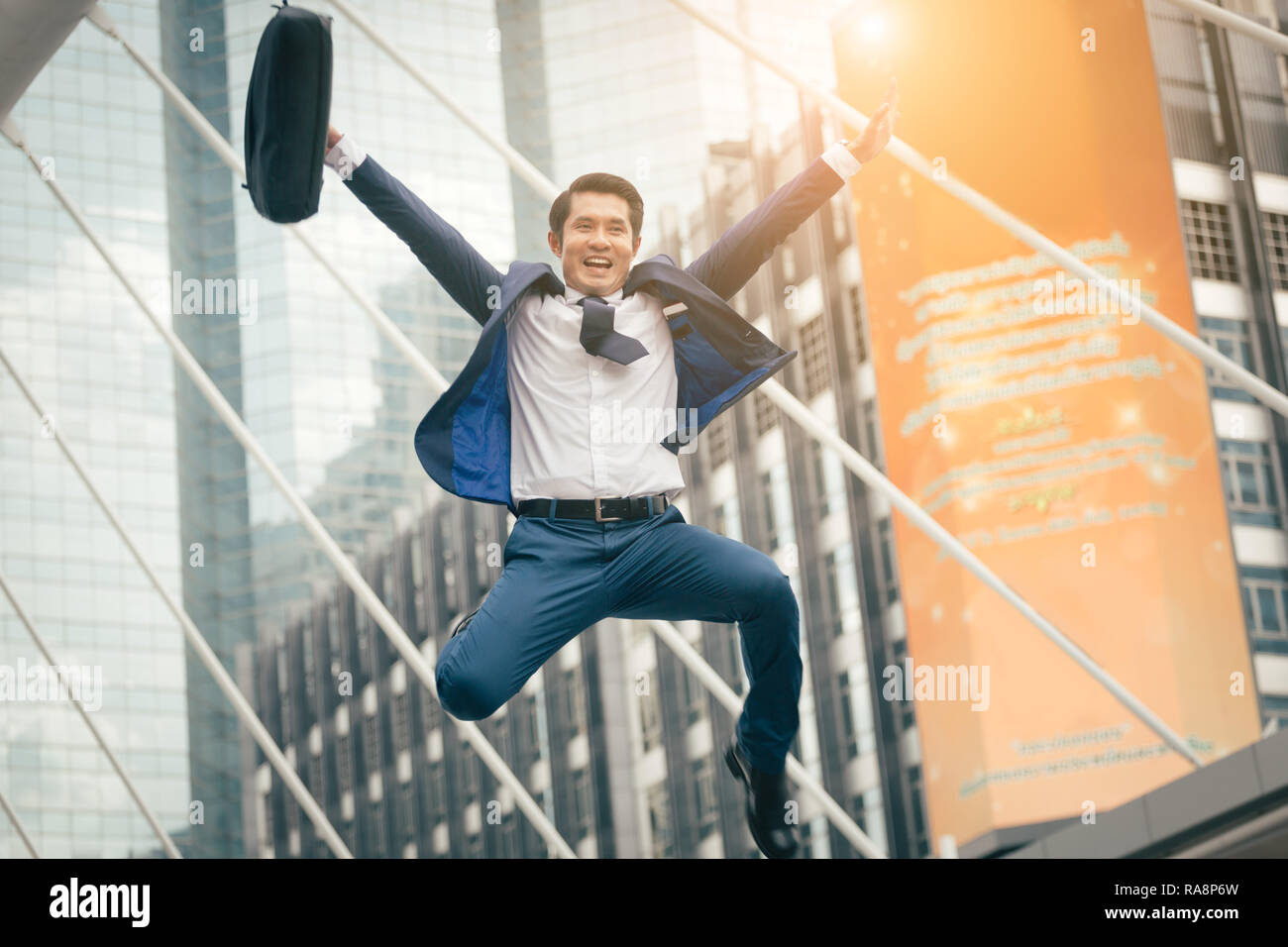 A business man jump to catch the sunlight because of success Stock ...