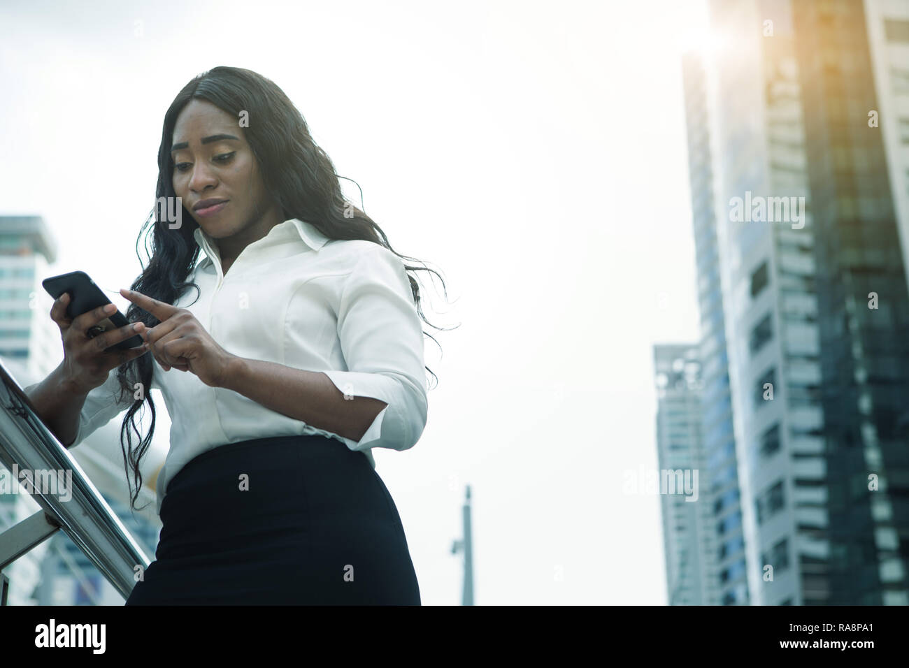 Black business woman use mobile phone technology Stock Photo - Alamy