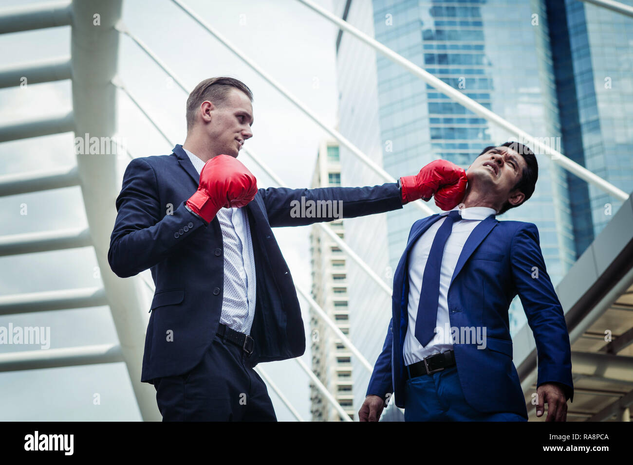 two business man fighting together use boxing mitts, competitor concept ...