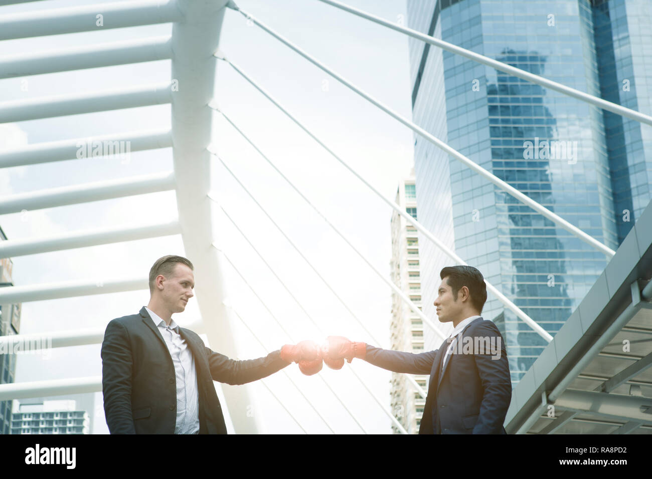 two business man fighting together use boxing mitts, competitor concept ...