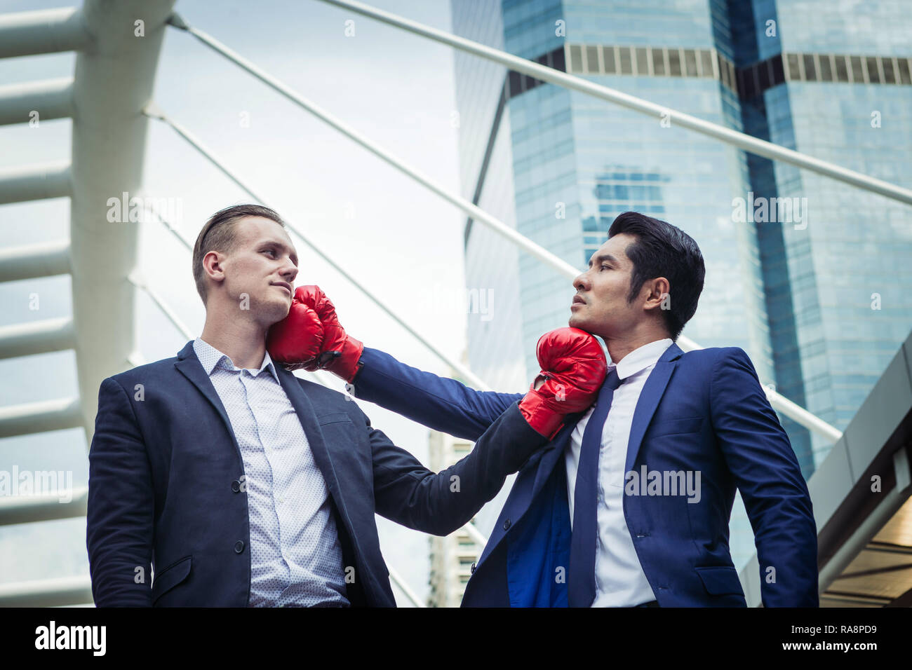 two business man fighting together use boxing mitts, competitor concept ...