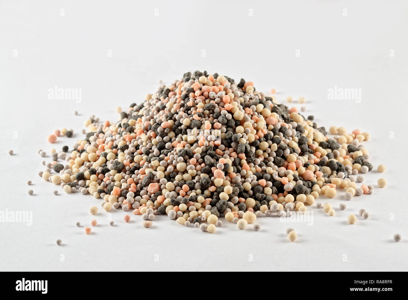 Heap of mineral fertilizers closeup on white background Stock Photo - Alamy