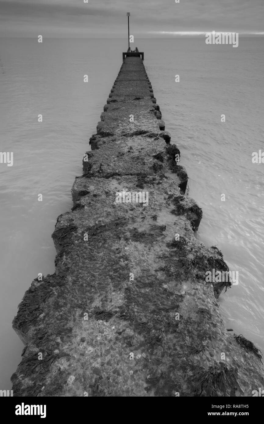 Sea defences and navigation markers at Elmer Sands beach near Middleton ...