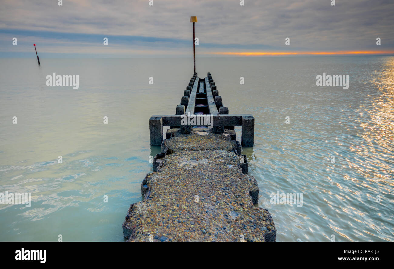 Sea defences and navigation markers at Elmer Sands beach near Middleton ...