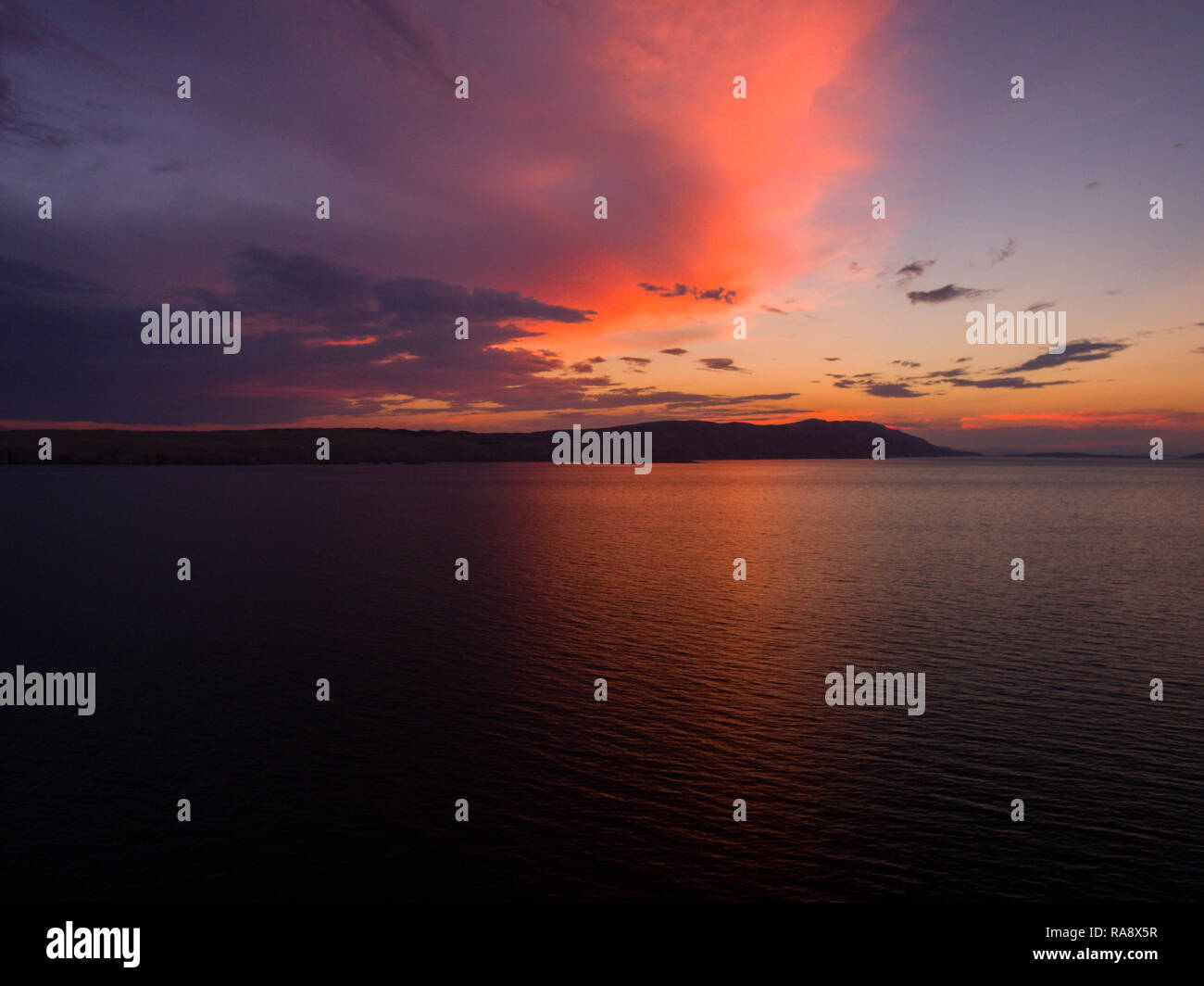 Aerial photo of dramatic sunset and view of seaside and island on it ...