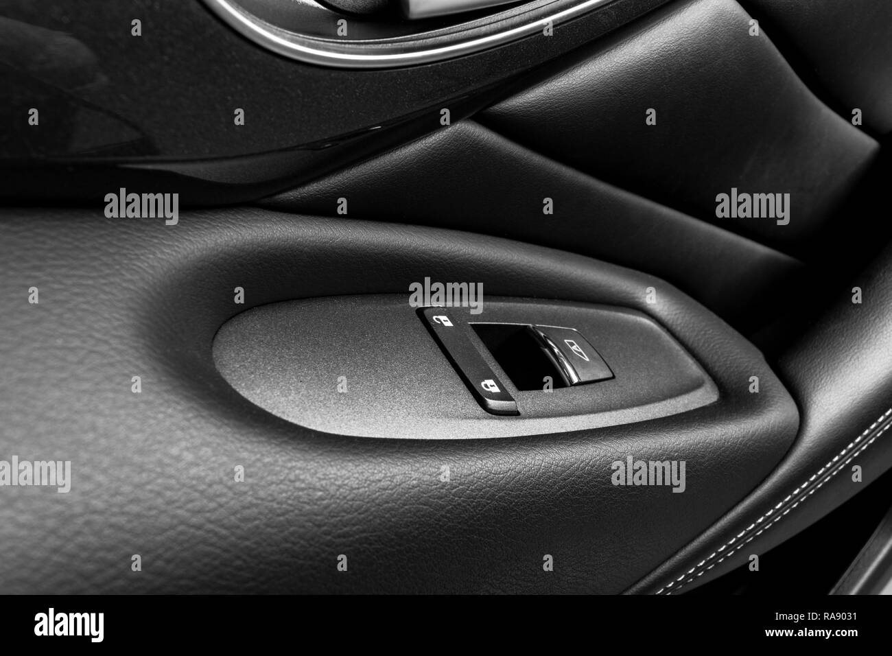 Door handle with Power window control buttons of a luxury passenger car ...