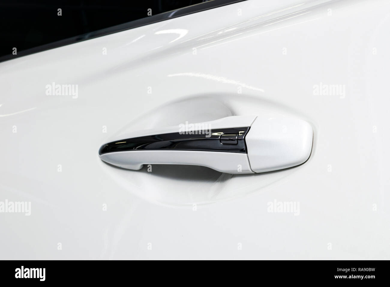 The modern door handle of a white car. Car detailing. Car exterior ...