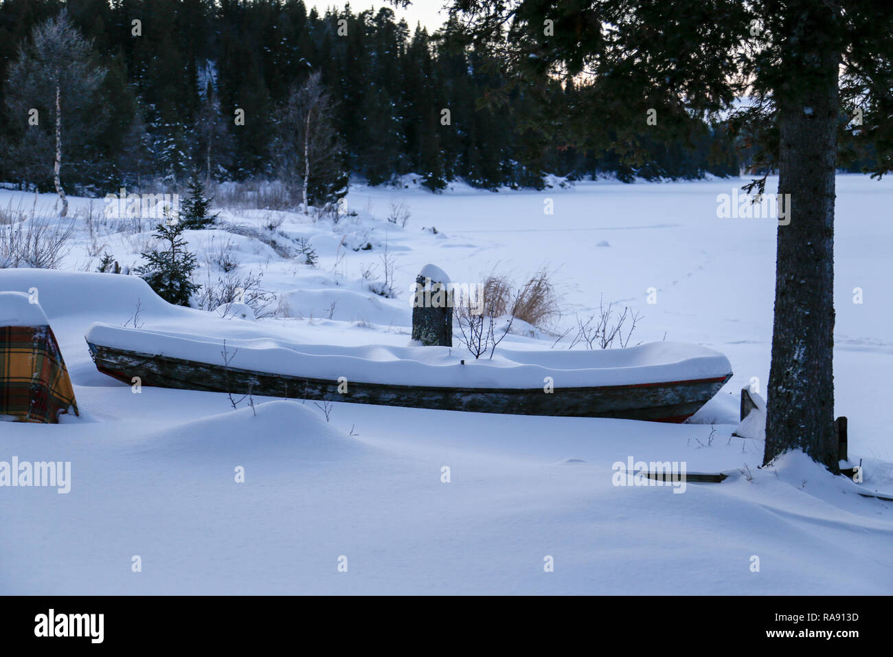 Snow covered rowing boat Stock Photo - Alamy