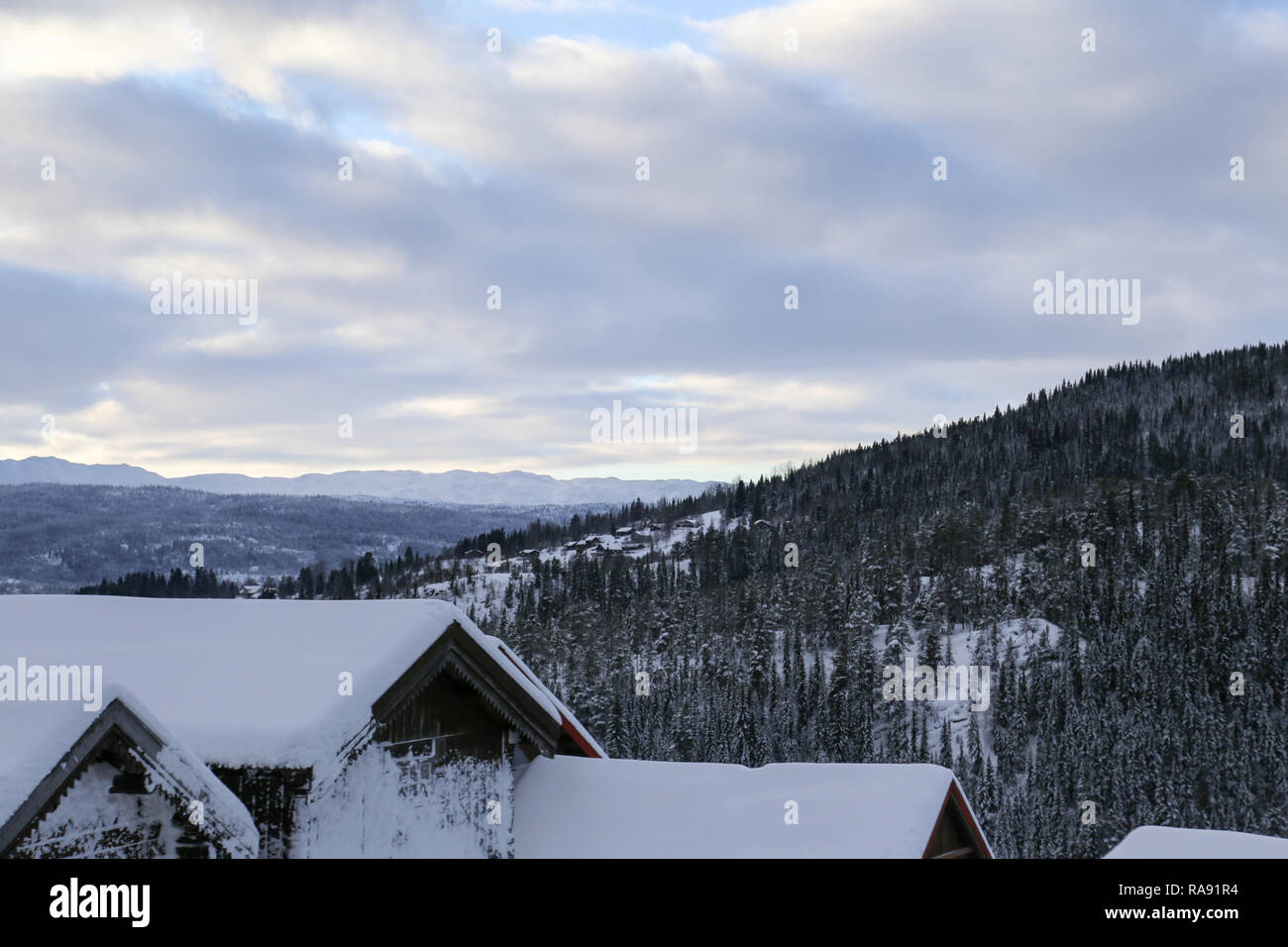 Norwegian cabin roof with snow covered mountain scene Stock Photo - Alamy