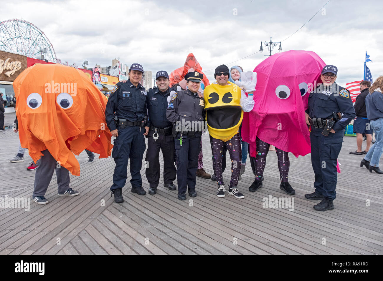 Police and 4 people dressed as Pacman characters pose prior to the ...