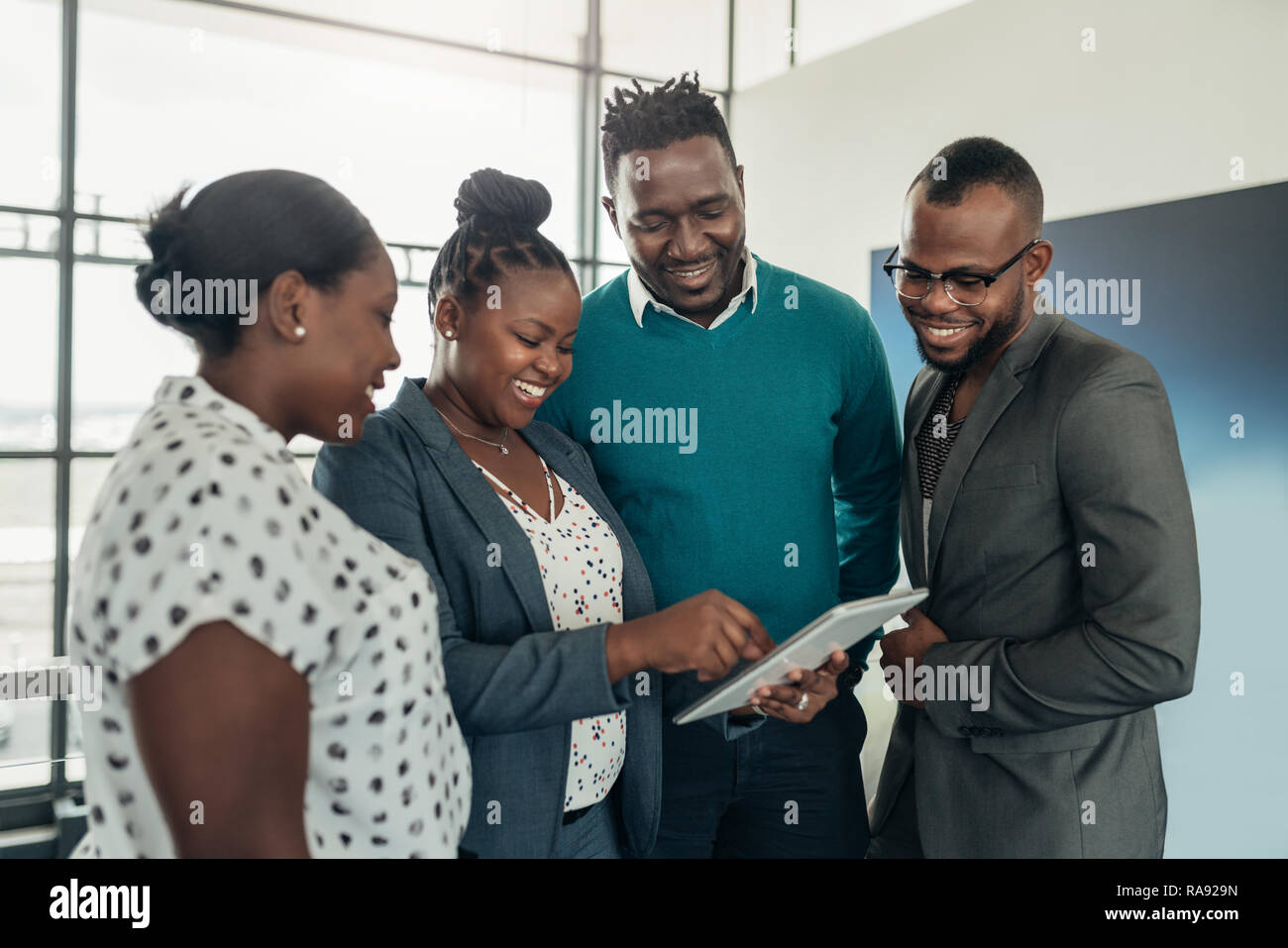 Team of african business people standing and smiling and laughing while ...