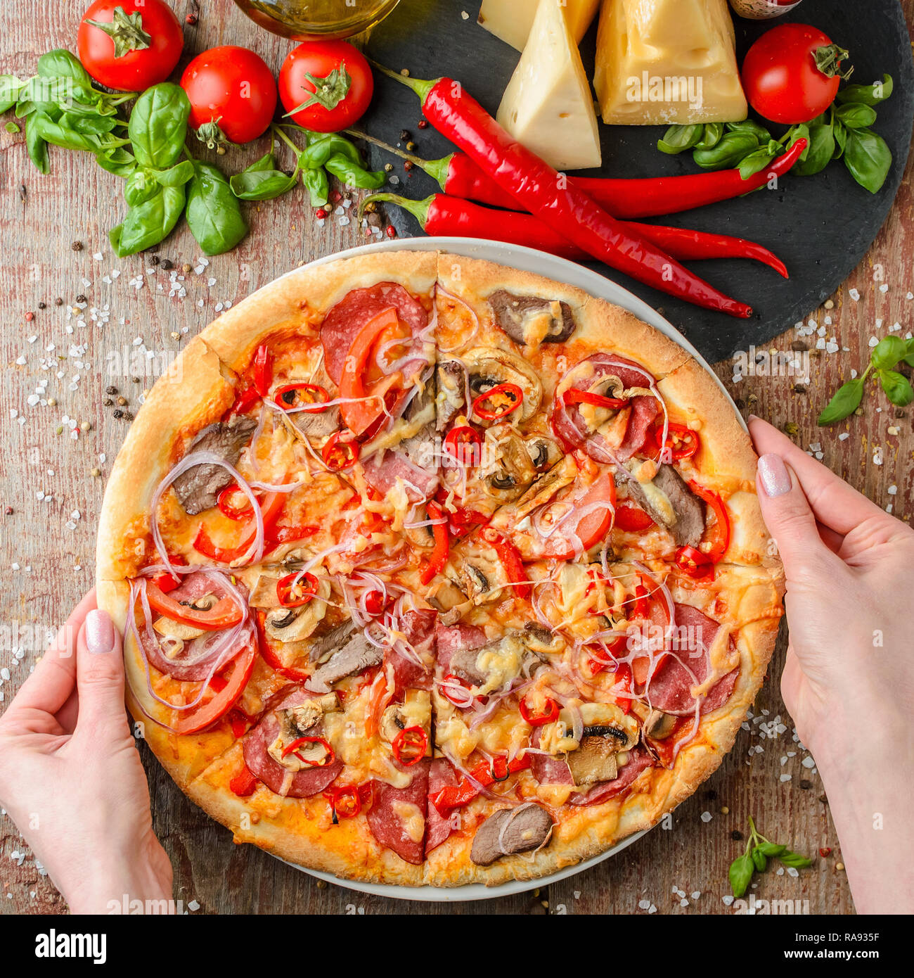Hands take slices of pizza hi-res stock photography and images - Alamy