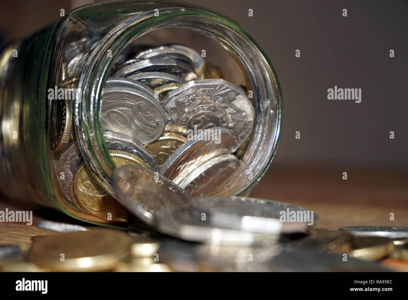 taking coins from savings jar Stock Photo - Alamy