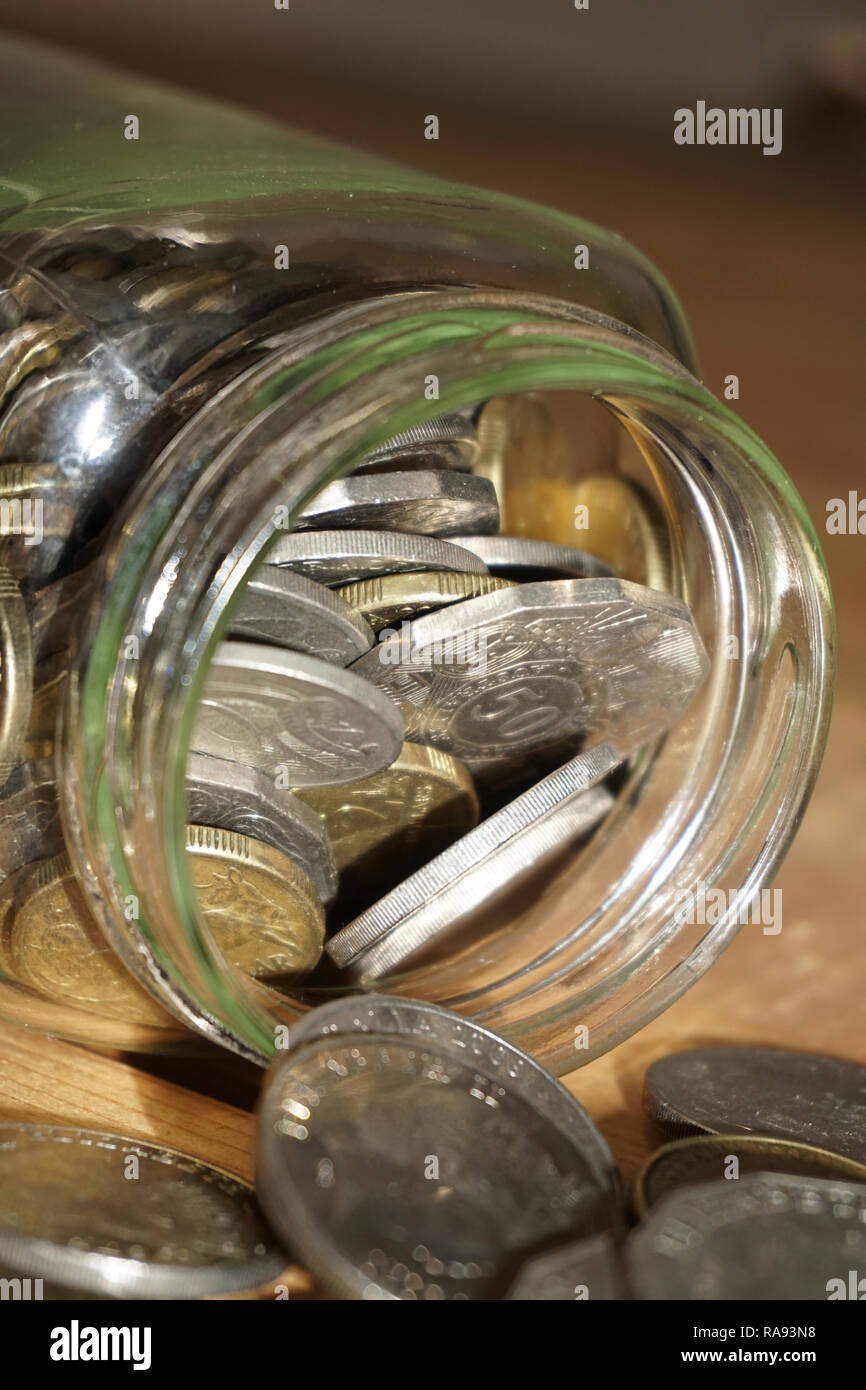 taking coins from savings jar Stock Photo - Alamy