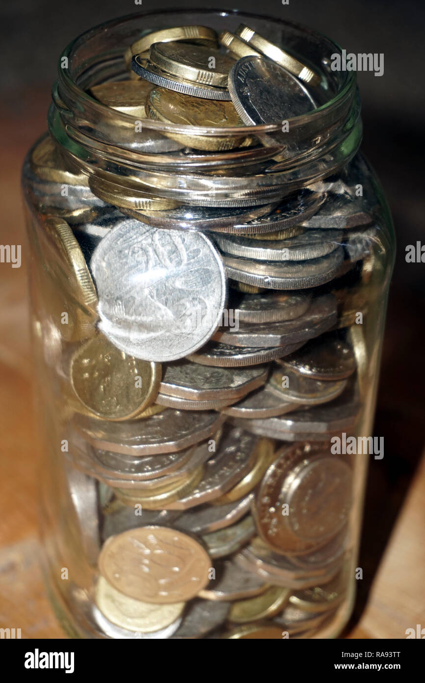 Australian coins filling up a glass jar Stock Photo - Alamy