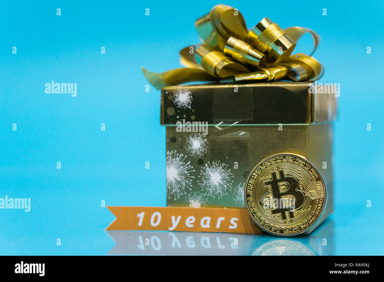 Bitcoin celebrating birthday, coin with birthday golden present behind ...