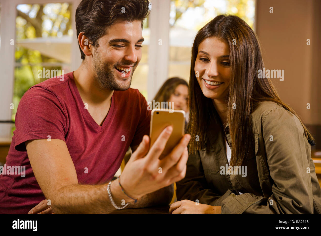 Young happy couple showing something hi-res stock photography and ...
