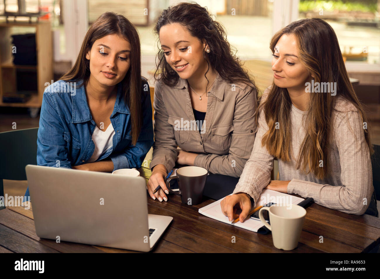 Group of beautiful female friends studying together Stock Photo - Alamy