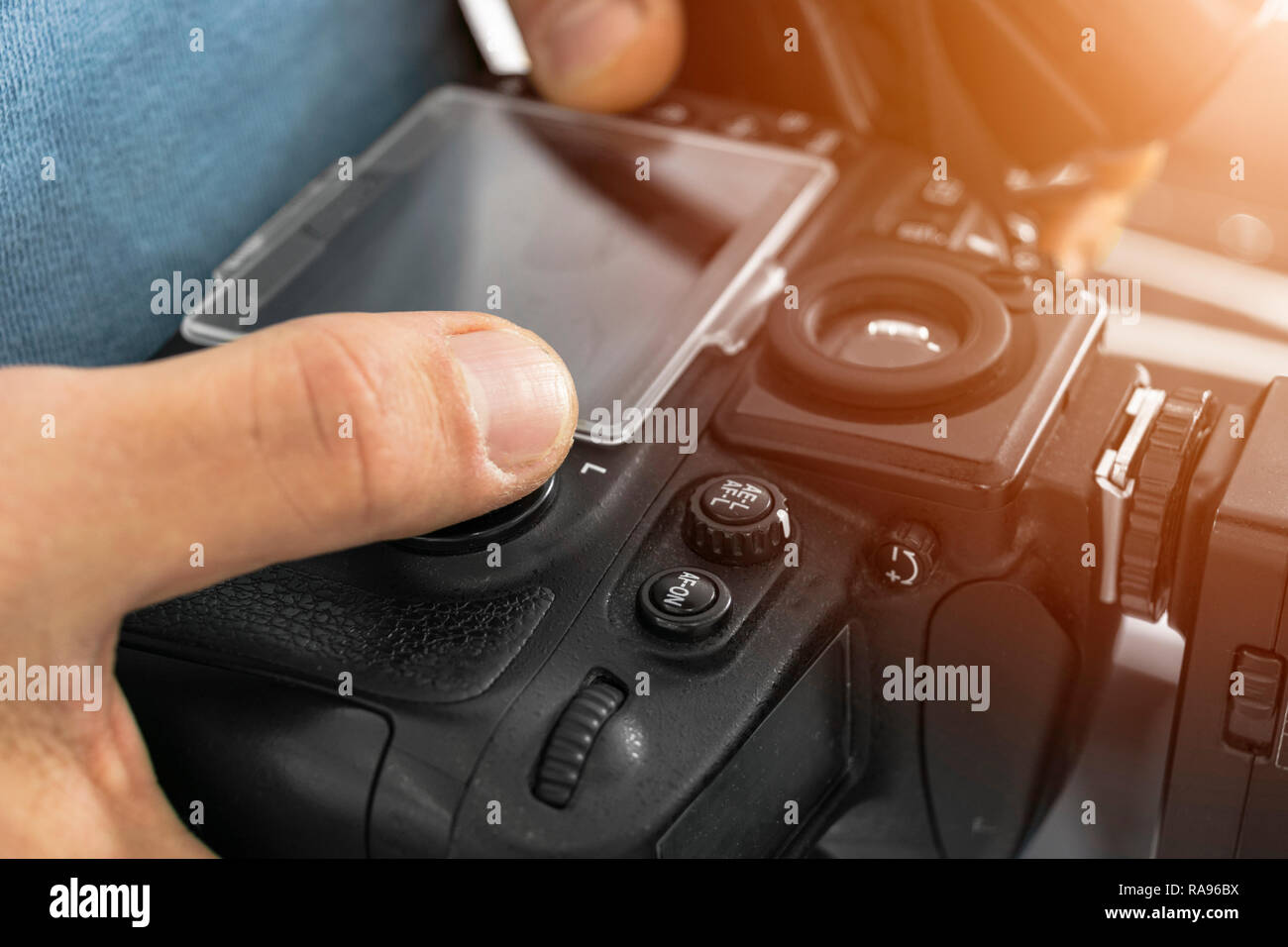 Digital single lens reflex camera in male hands. Photographer shooting ...