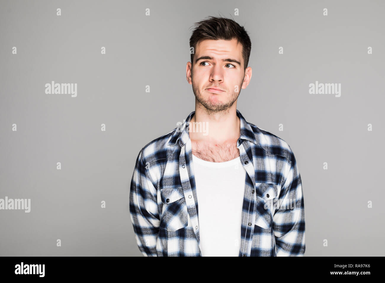 Close up portrait of a young man with a confused, thinking face Stock ...