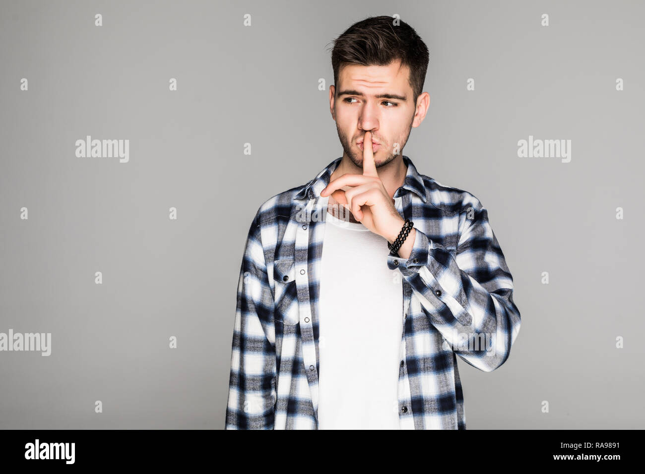 Portrait of serious fashionable male dressed trendy in blue shirt ...