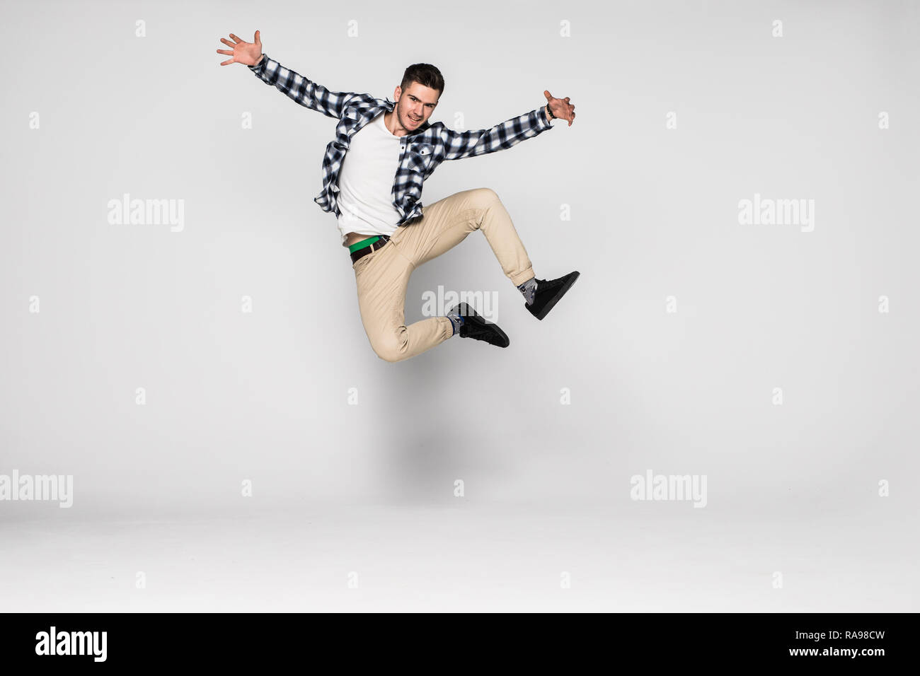 Smiling joyful man jumping on a white background Stock Photo - Alamy