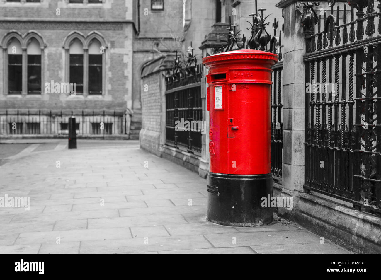 The traditional British red post box in London standing on the street ...