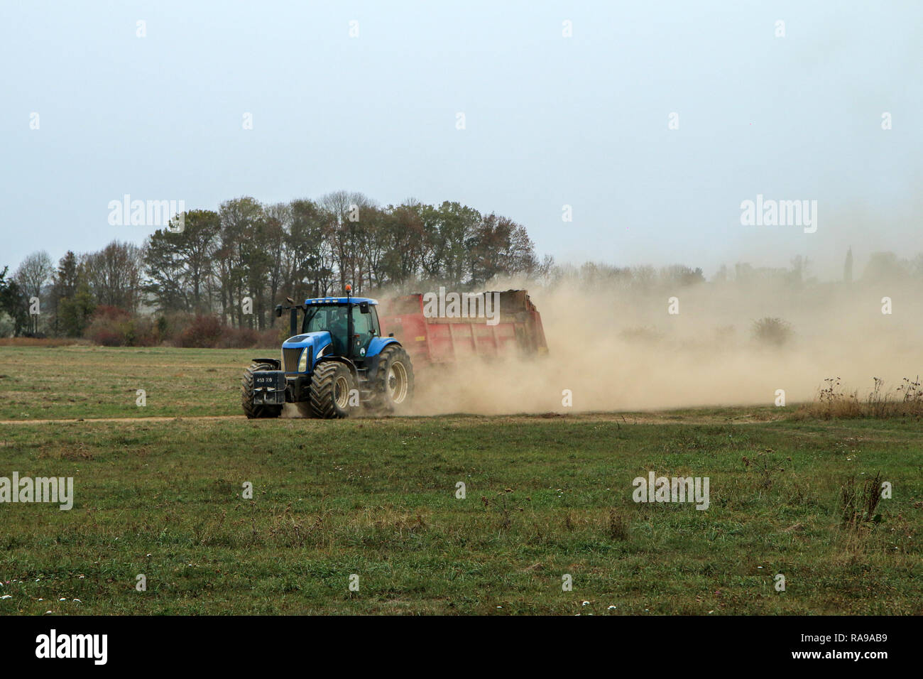 A picture of a tractor on a field during autumn. Working hard while ...